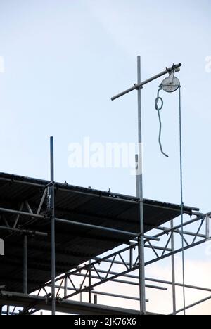 Pulley on scaffolding above new house construction to enable material ...