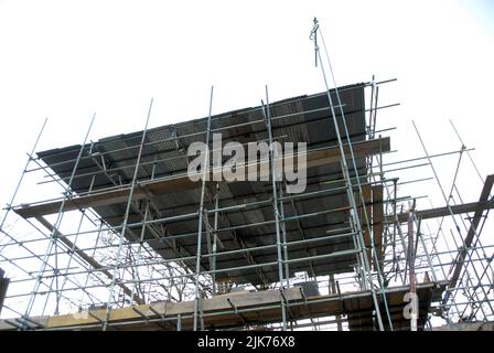 Scaffolding covered with corrugated iron sheeting above a new house ...