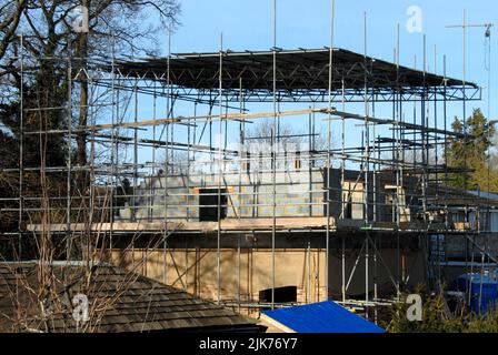 Scaffolding covered with corrugated iron sheeting above a new house ...