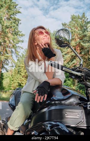 Beautiful woman driving a motorcycle on a mountain road Stock Photo - Alamy