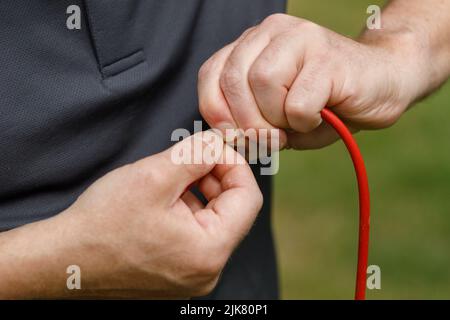 Hands connecting electrical wires together. Male hands and fingers ...