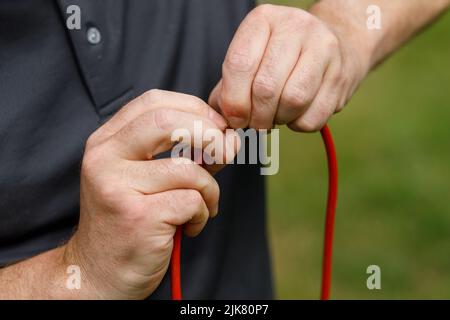 Hands connecting electrical wires together. Male hands and fingers ...