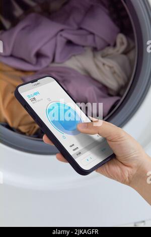 aesthetic laundry concept Connecting washing machine app with mobile ...