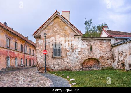 facade with red bricks and old peeling windows of an old industrial ...