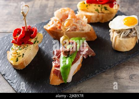Assortment of Spanish pintxos on wooden table Stock Photo - Alamy