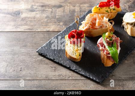 Assortment of Spanish pintxos on wooden table Stock Photo - Alamy