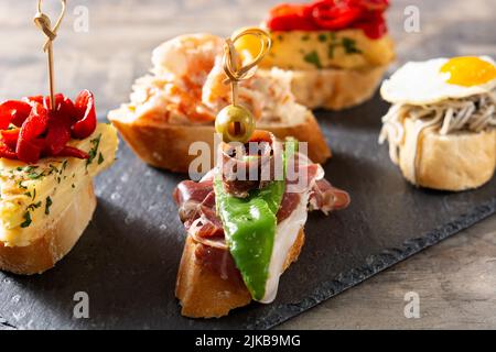 Assortment of Spanish pintxos on wooden table Stock Photo - Alamy