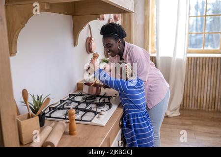 A woman and a girl looking busy while doing some housework Stock Photo ...