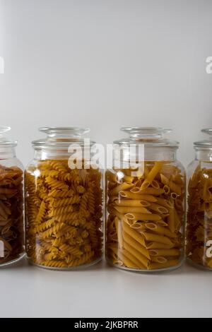 Different types of italian pasta standing next to each other in a glass ...