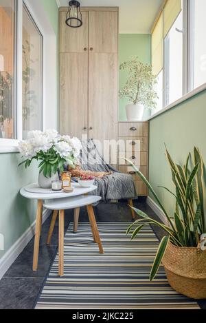 Sitting area in balcony with comfortable furniture around beautiful ...