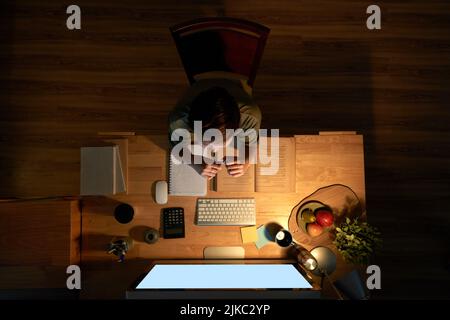 Young female student preparing for exams with many books and chained to ...