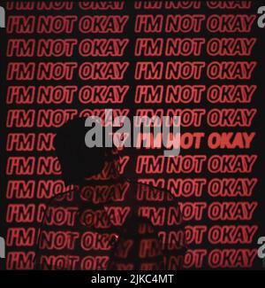 A projector photography with red 'I'm not okay' text and human shadow ...