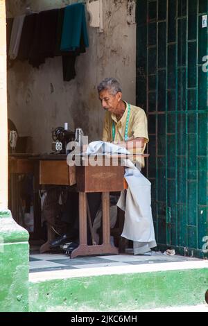 CARTAGENA DE INDIAS, COLOMBIA - AUGUST, 2011: Street sweeper in orange ...