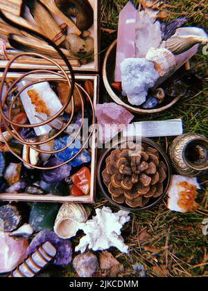 A vertical shot of crystal stones, palo santo and smudge sticks for ...