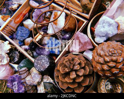 A vertical shot of crystal stones, palo santo and smudge sticks for ...