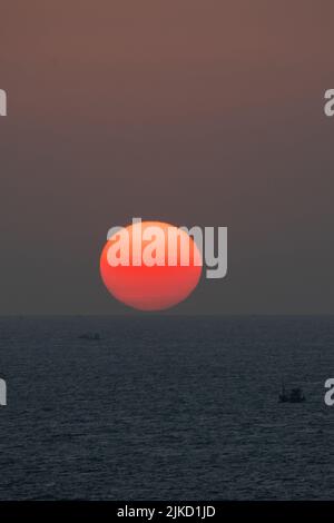 A vertical shot of a beautiful mirage sunset on the sea Stock Photo - Alamy