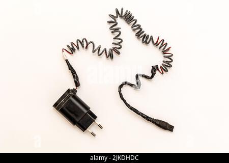 Charred charger wire, close-up. White background. Closeup. Short ...