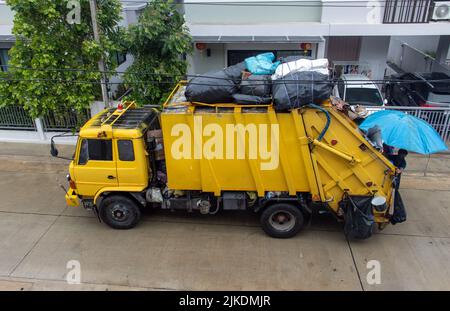 Garbage truck driving on the street Stock Photo - Alamy