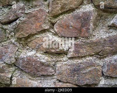 Ancient stonework. The stones are reinforced with old mortar. Uneven ...