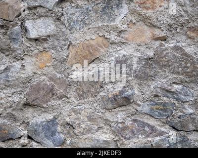 Ancient stonework. The stones are reinforced with old mortar. Uneven ...