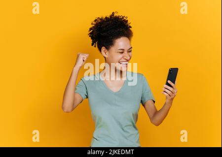 Surprised happy lucky girl winning online internet lottery smiling ...