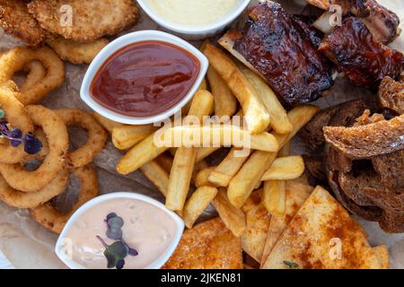 a set of different types of products fried together, French fries ...