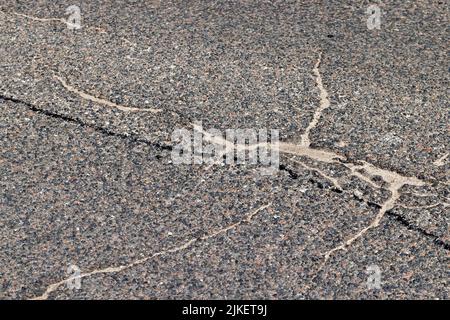 poor paved road with a lot of holes and potholes, poor transport ...