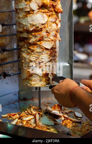 Chef cutting with doner knife Traditional Turkish Doner Kebab meat ...