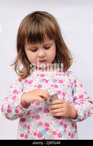 Little baby eating raspberry from decorative metal bucket. Child ...