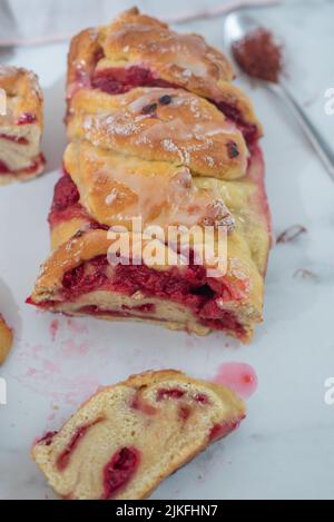 Sweet home made saffron raspberry babka on a table Stock Photo - Alamy