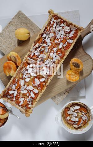 Homemade rectangular shortbread pie with apricots and peaches. White ...
