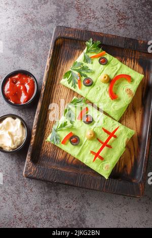 Halloween party Children's food monster burritos with sauces on a ...