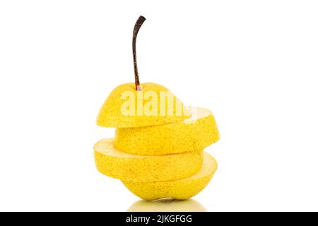 One juicy yellow pear cut into quarters and one whole pear, close-up ...