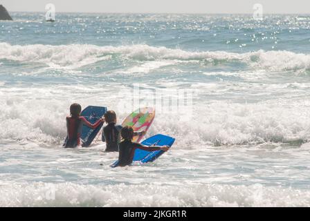 Boy boogie boarding at West Dale beach, Pembrokeshire, Wales, UK Stock ...