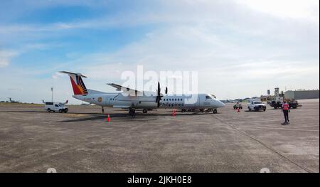 A medium-sized plane parked on the tarmac in an airport, ready for ...