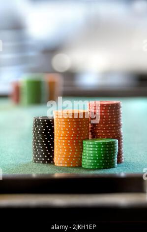 A closeup shot of stacks of poker chips with money and cards Stock ...