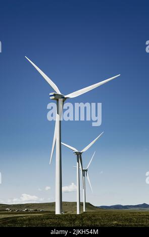 A vertical shot of wind turbines in the beautiful forest Stock Photo ...