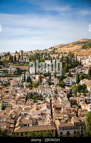 Panoramic view of the beautiful Granada City under the blue cloudy sky ...