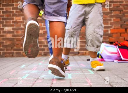 multiethnic kids playing hopscotch on school playground. back to school ...
