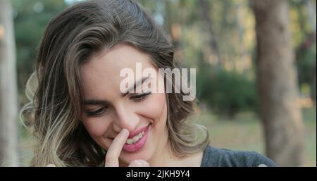 Authentic girl scratches nose Stock Photo - Alamy