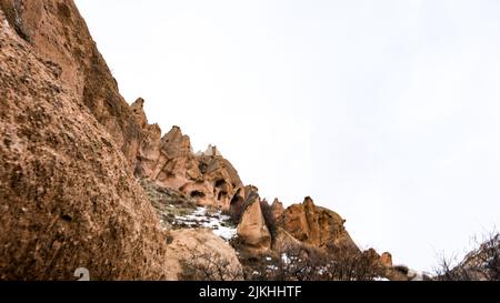 Geological snowy formations in Cappadocia, Turkey over a white ...