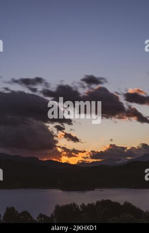 Scenic shot of a calm lake surrounded by trees in a forest Stock Photo ...