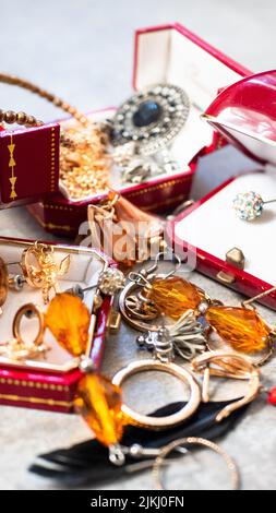 Old red boxes full of jewelry. Treasure chest, close up Stock Photo - Alamy