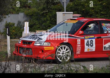 A red Mitsubishi Lancer vintage car rally in race. San Marino Stock ...