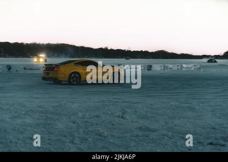 A yellow sports car drifting on ice and snow in Juneau, Alaska Stock ...
