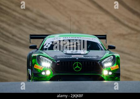 A long exposure shot of a Mercedes-AMG GT3 pink car during the race in ...