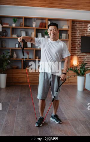 Full body shot of mature Asian businesswoman with Wai as Thai greeting ...