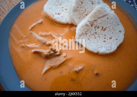 Traditional chicken hen on paprika or paprica creamy sauce with bread ...