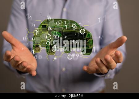 A 3D rendered hologram of a car and binary code hovering over a man's ...