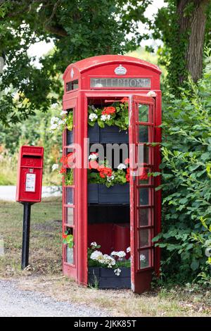 Red telephone box filled with flowers Stock Photo - Alamy